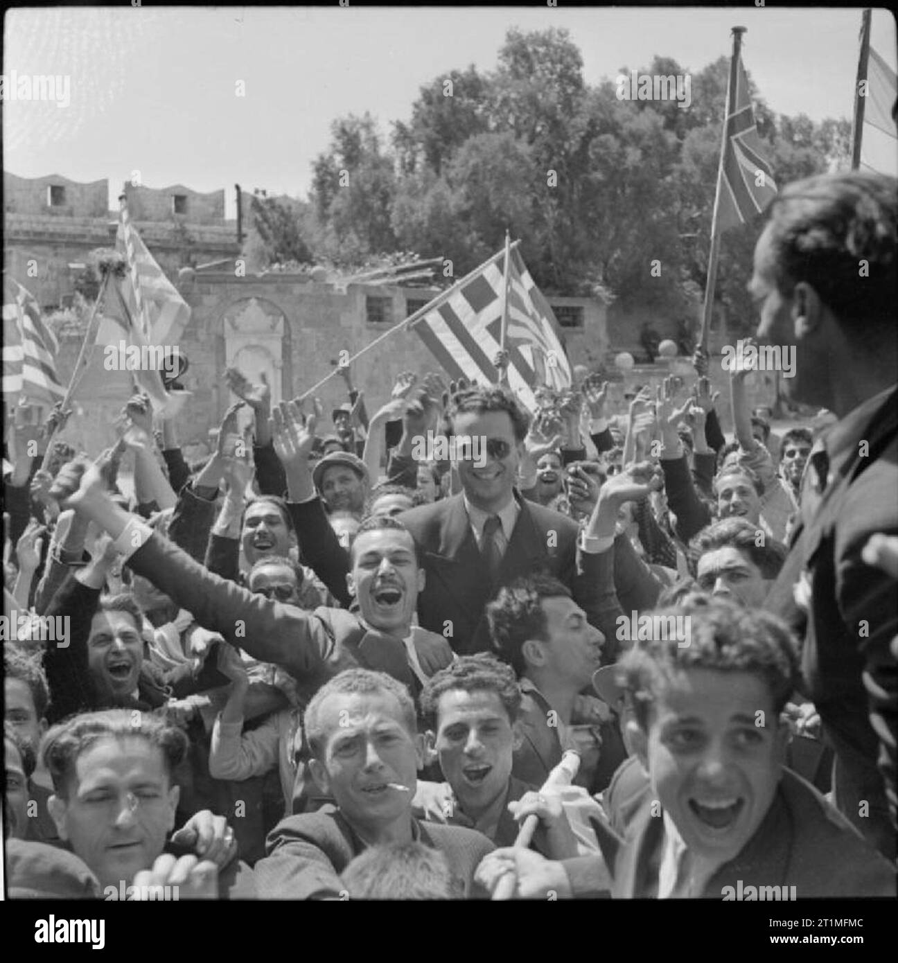 The Liberation of Rhodes, 1945 Crowds of civilians carrying Greek ...