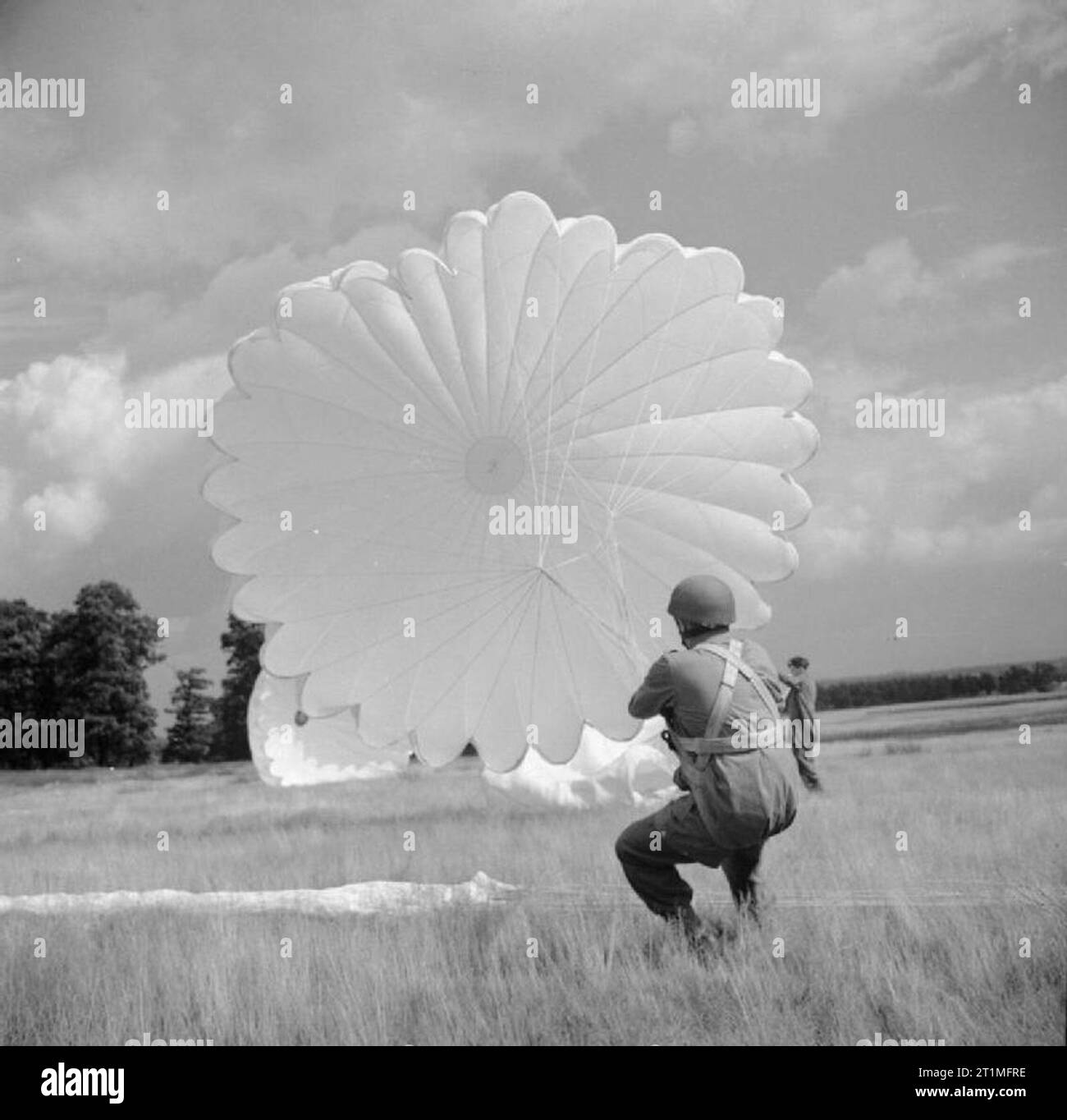 The Parachute Regiment in Training, August 1942 A paratrooper gathers ...