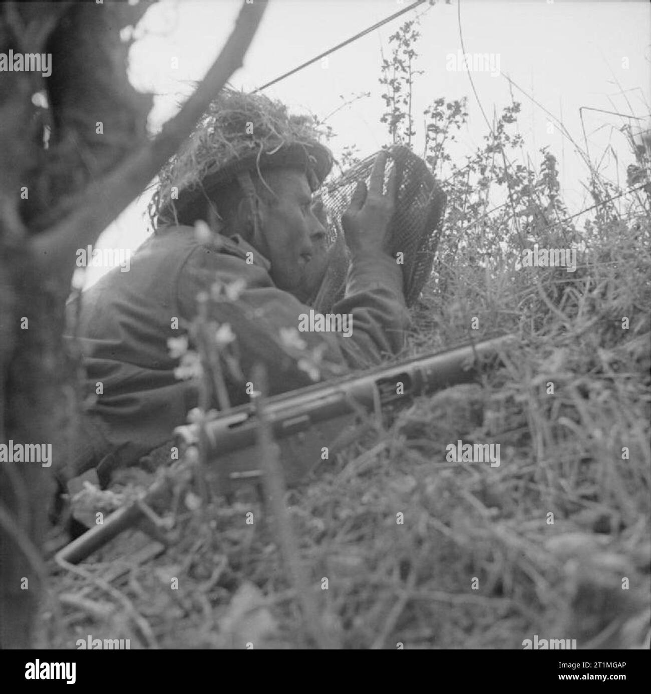 War Office Second World War Official Collection Using his face net as ...