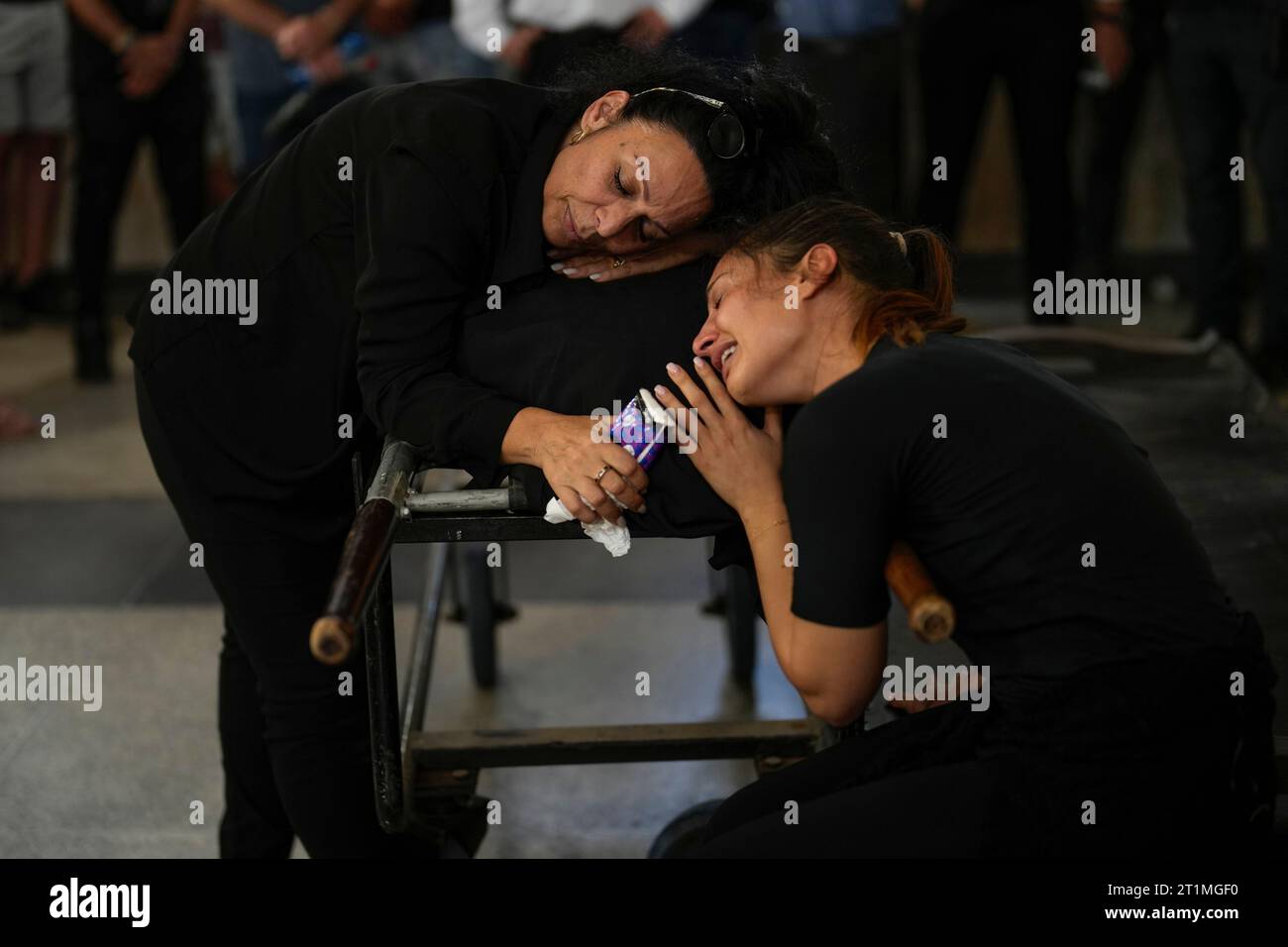 Mourners grieve beside the body of Mapal Adam during her funeral in Tel ...
