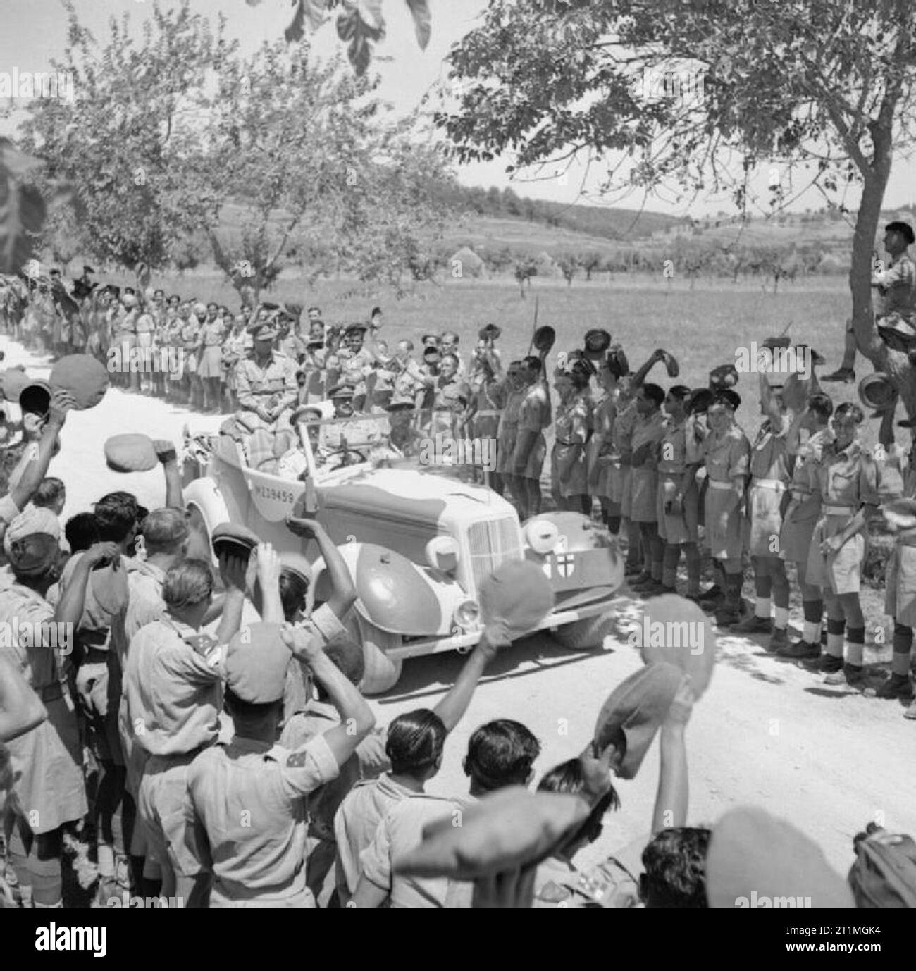 King George VI is driven past cheering Indian troops on his way to a ...
