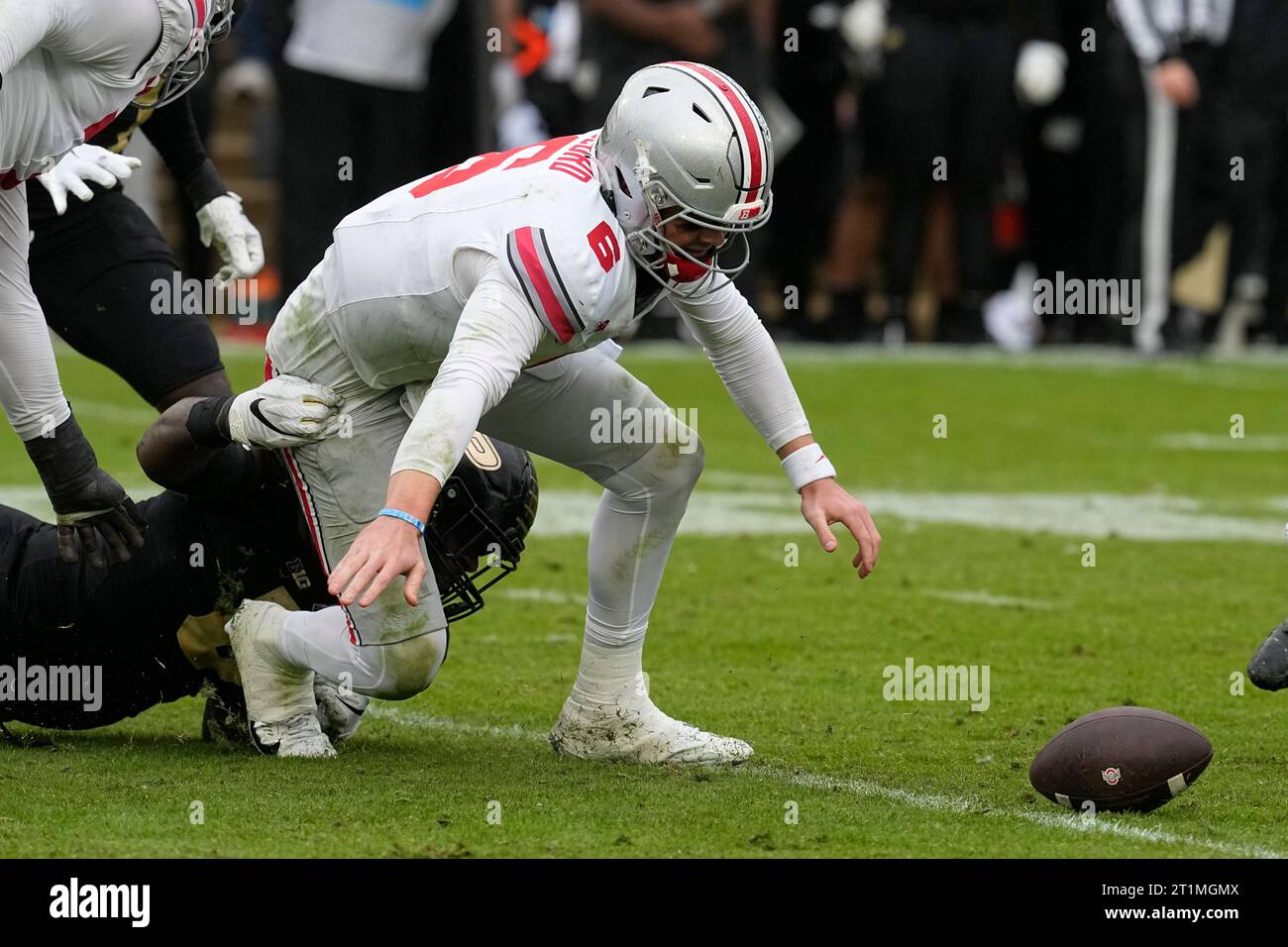 Ohio State quarterback Kyle McCord (6) fumbles while being tackled by ...
