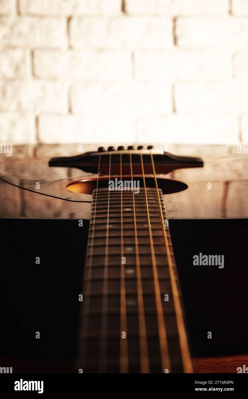 Dark toned perspective view of acoustic guitar frets and string in the ...