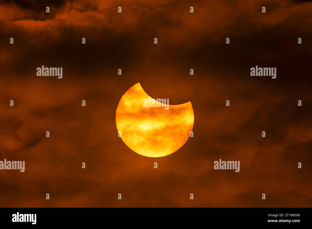 The annular eclipse peeks through partly cloudy skies over Boise ...
