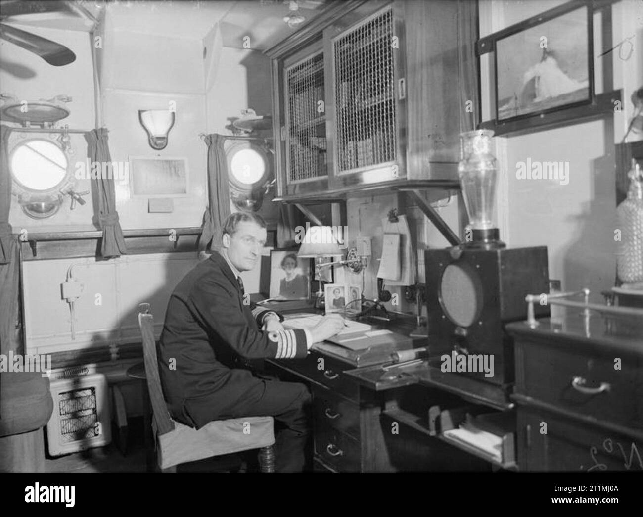 Captain (d) a K Scott-moncrief, Rn, at His Desk in His Cabin Aboard HMS ...