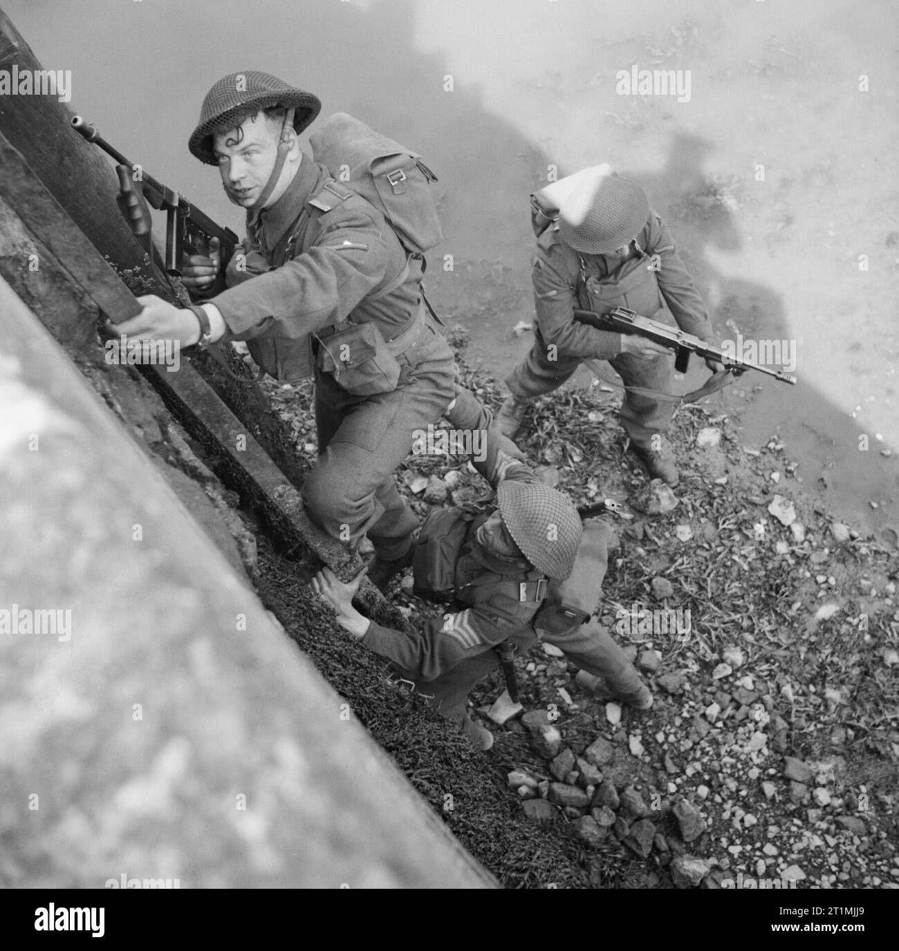 Men of the South Staffordshire Regiment climb up onto a harbour wall ...