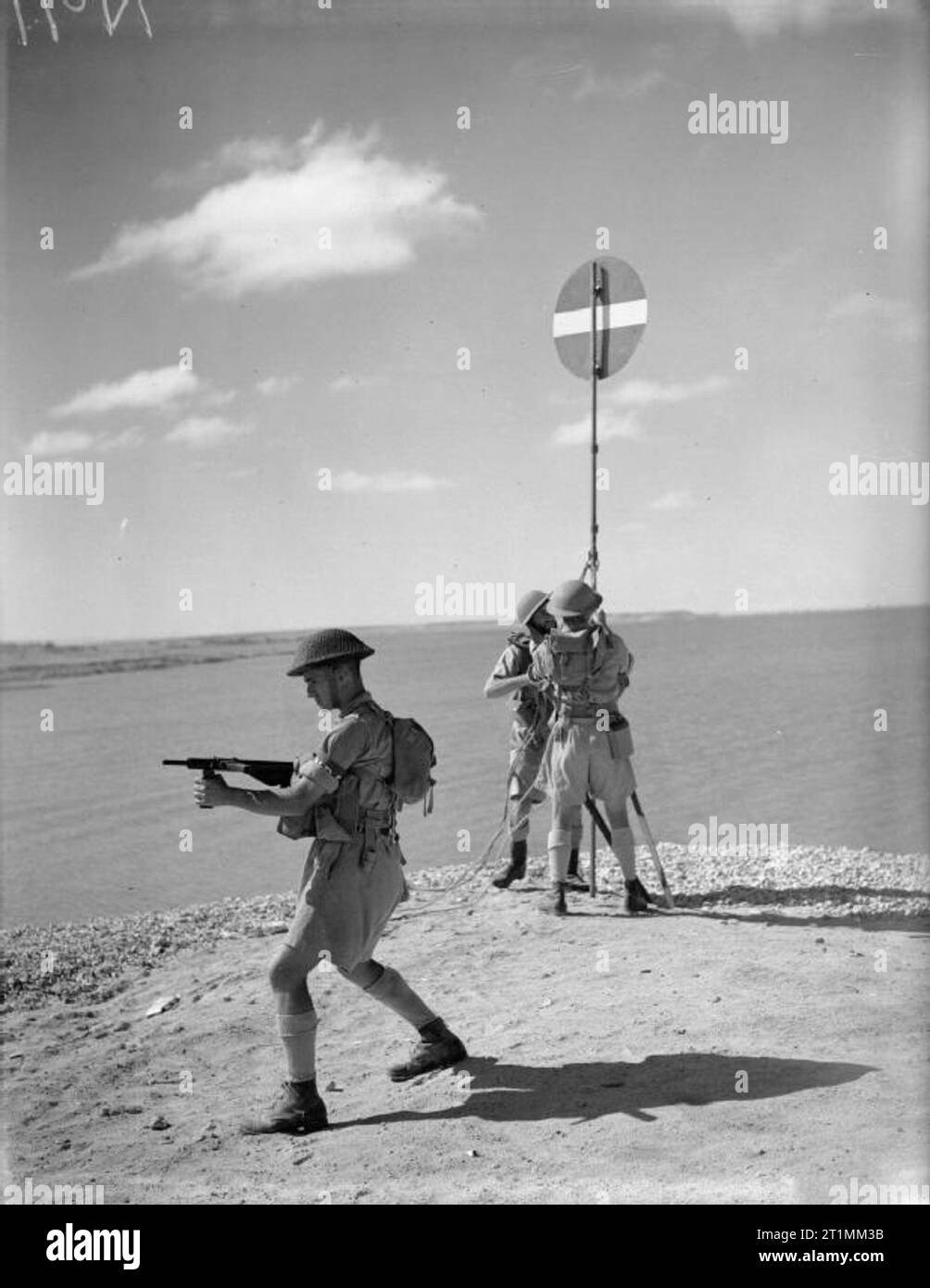 The Royal Navy during the Second World War Two men erecting a sign to ...