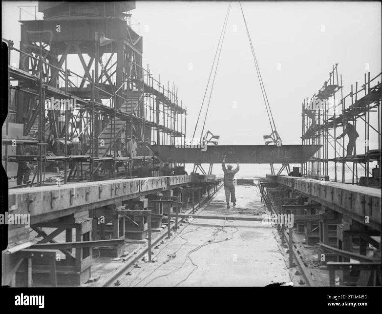 The Royal Navy during the Second World War Men lowering a bottom plate ...