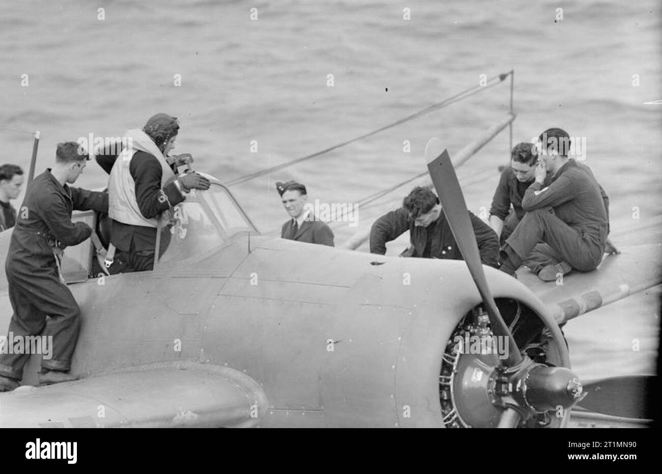 Fleet Air Arm Series, on Board HMS Victorious. September 1942. A pilot getting into an aircraft ...
