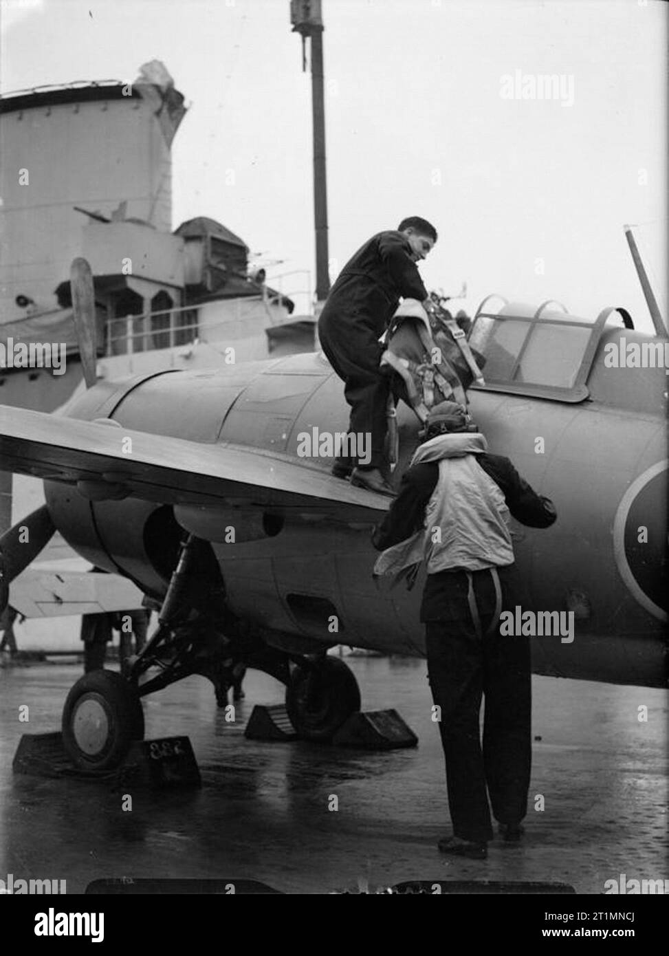 Fleet Air Arm Series, on Board HMS Victorious. September 1942. A pilot getting into an aircraft ...