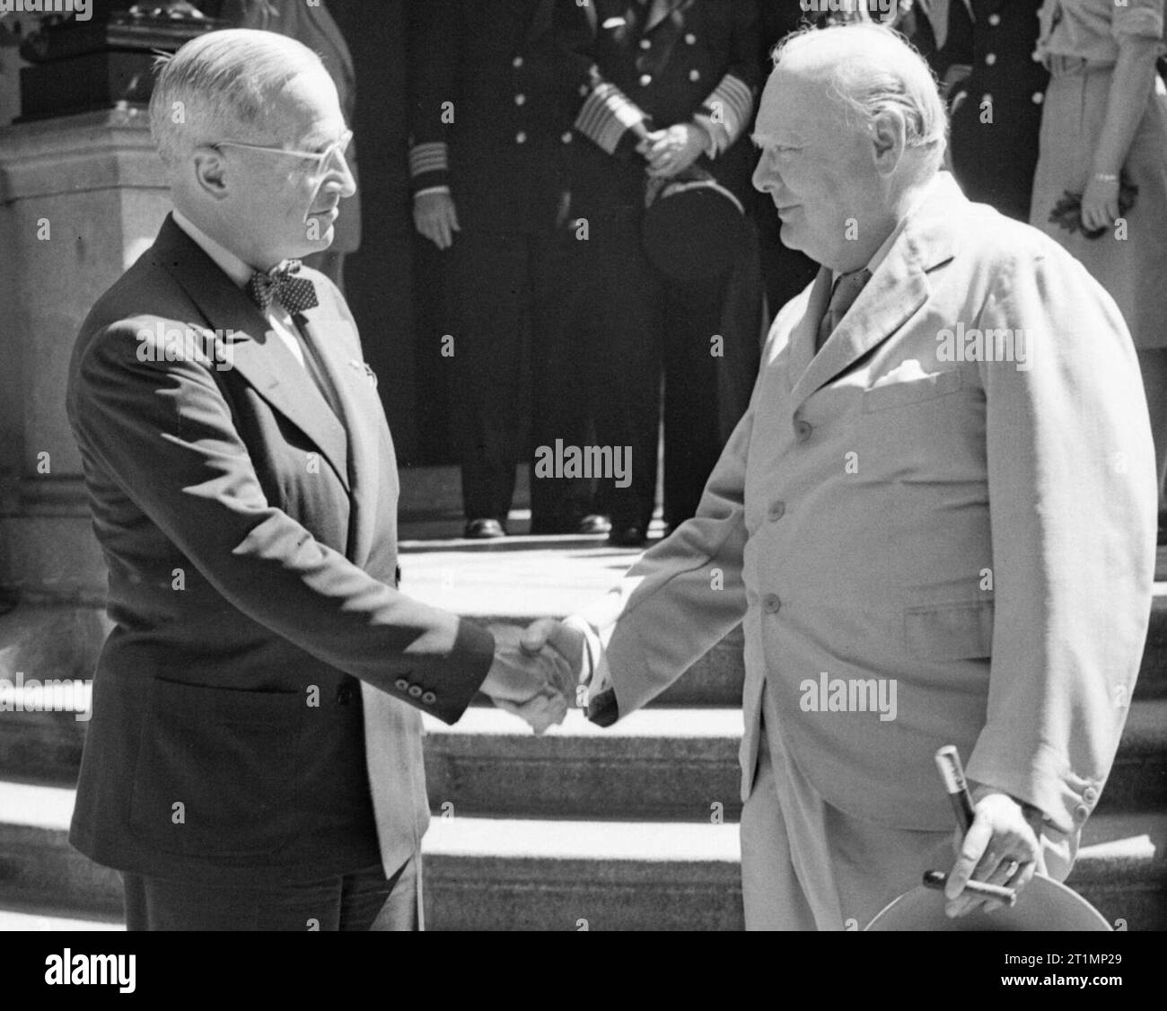 President Harry Truman and Winston Churchill shake hands on the steps ...