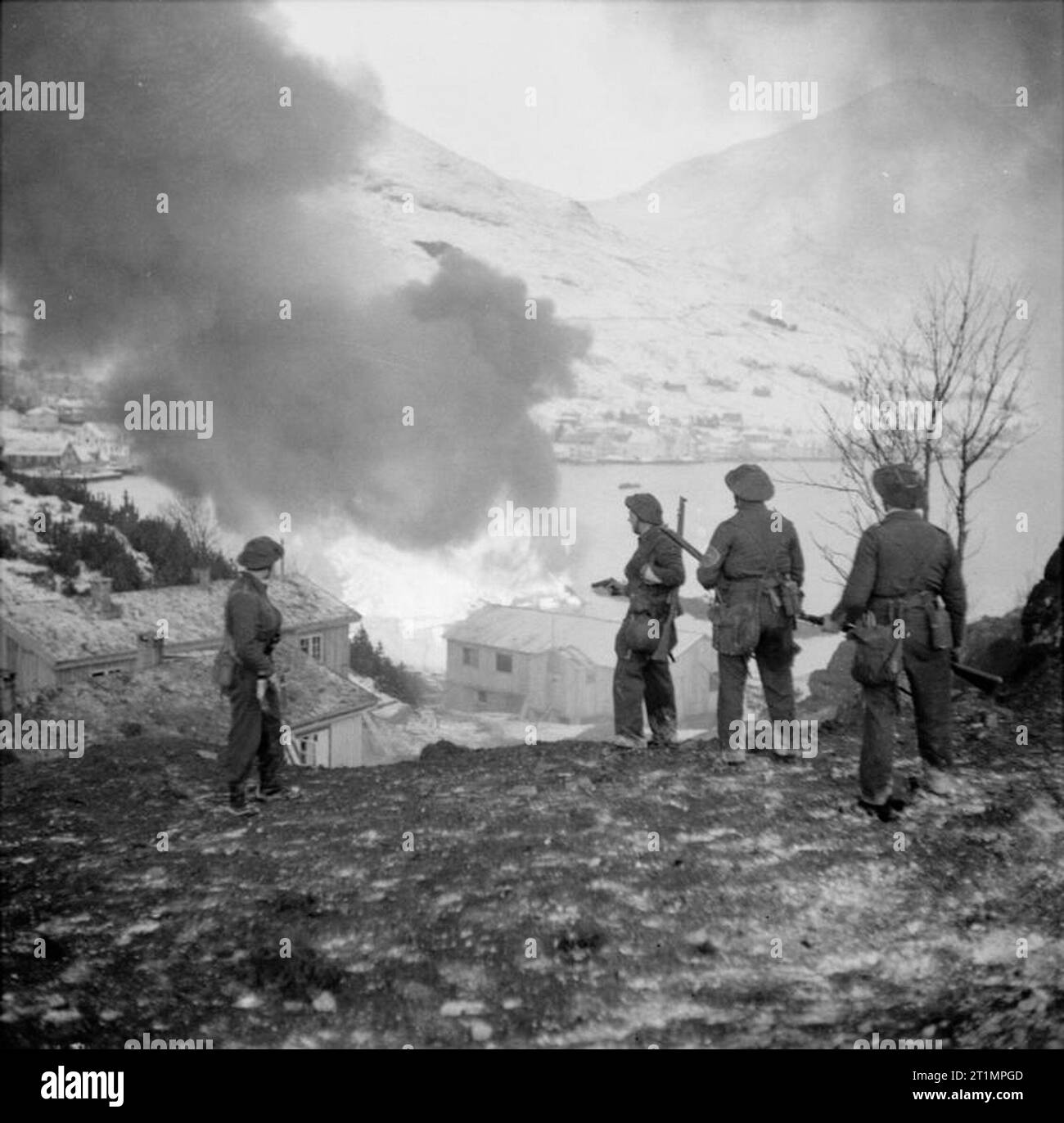 Raid on Vaagso, 27 December 1941 Commandos watch as an ammunition dump ...