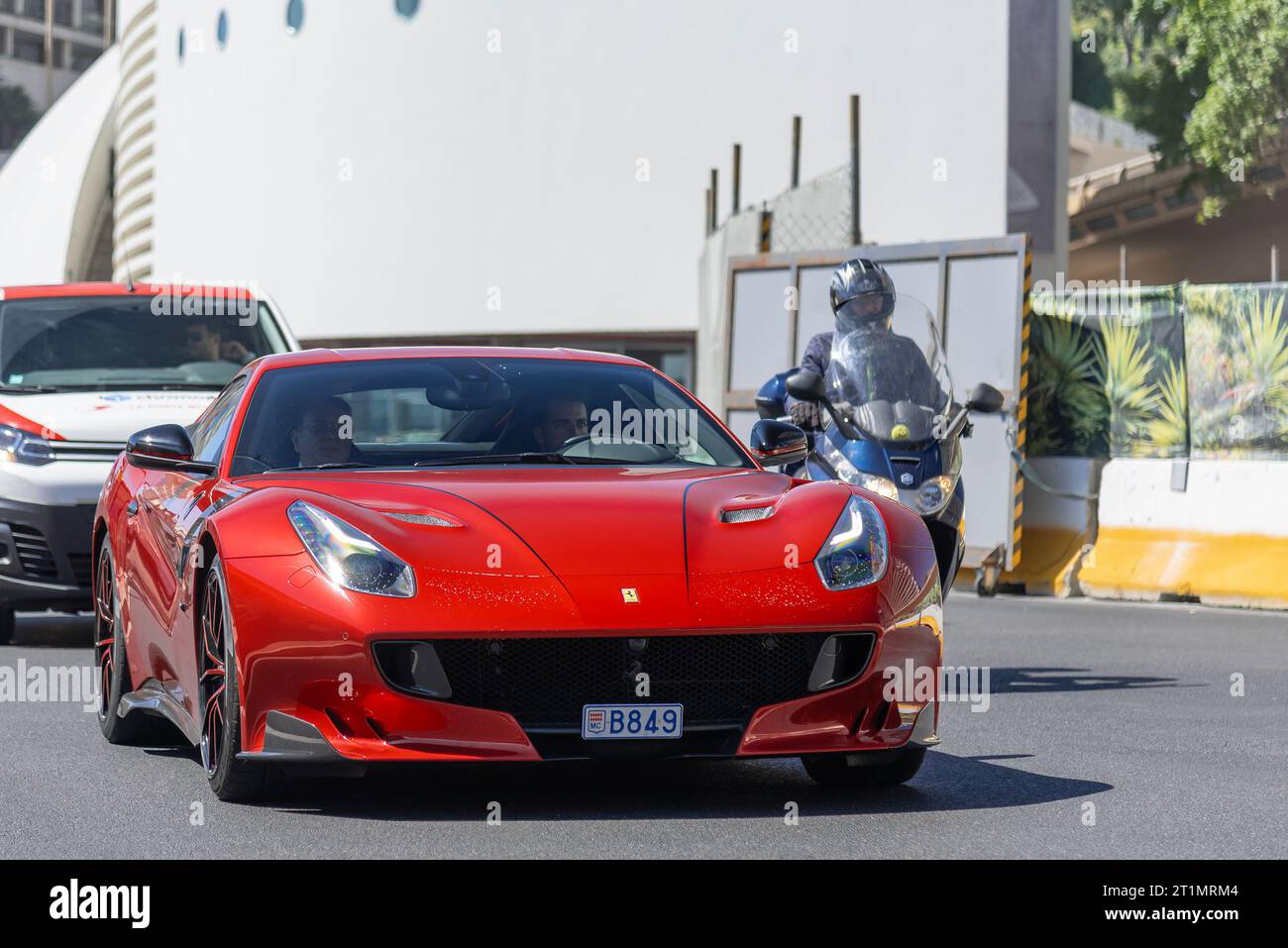 Rosso Fuoco Ferrari F12tdf driving on the road Stock Photo - Alamy