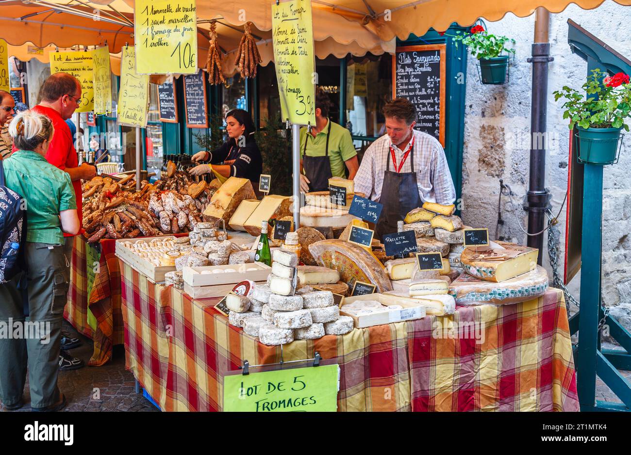 Cheese and meats stalls and displays of local produce in an outside ...