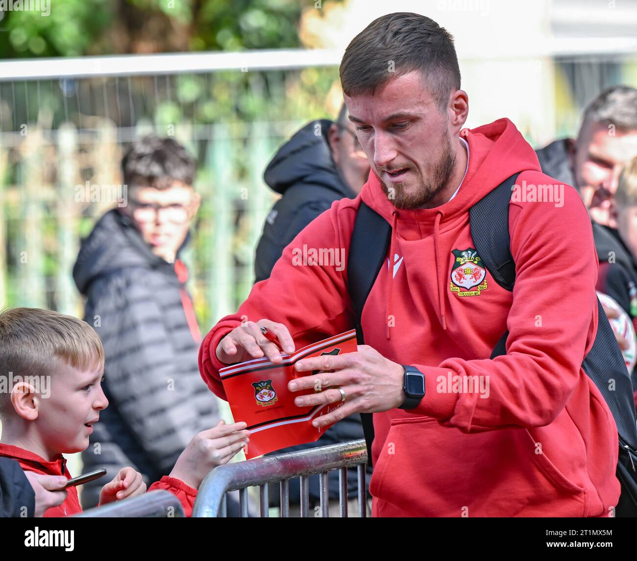 Luke Young 8# of Wrexham Association Football Club signs autographs as ...
