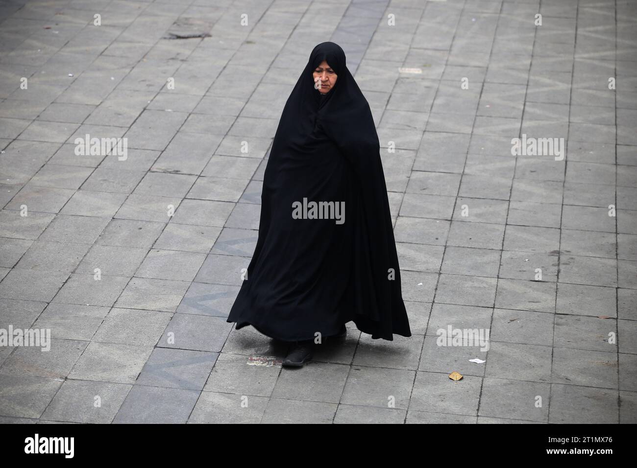 Tehran, Iran. 13th Oct, 2023. An Iranian veiled woman in a black chador ...