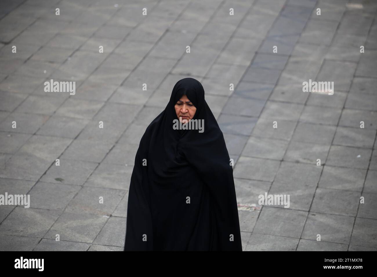 Tehran, Iran. 13th Oct, 2023. An Iranian veiled woman in a black chador ...