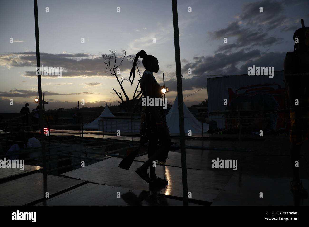 Nairobi, Kenya. 14th Oct, 2023. A model in silhouette hits the runway ...