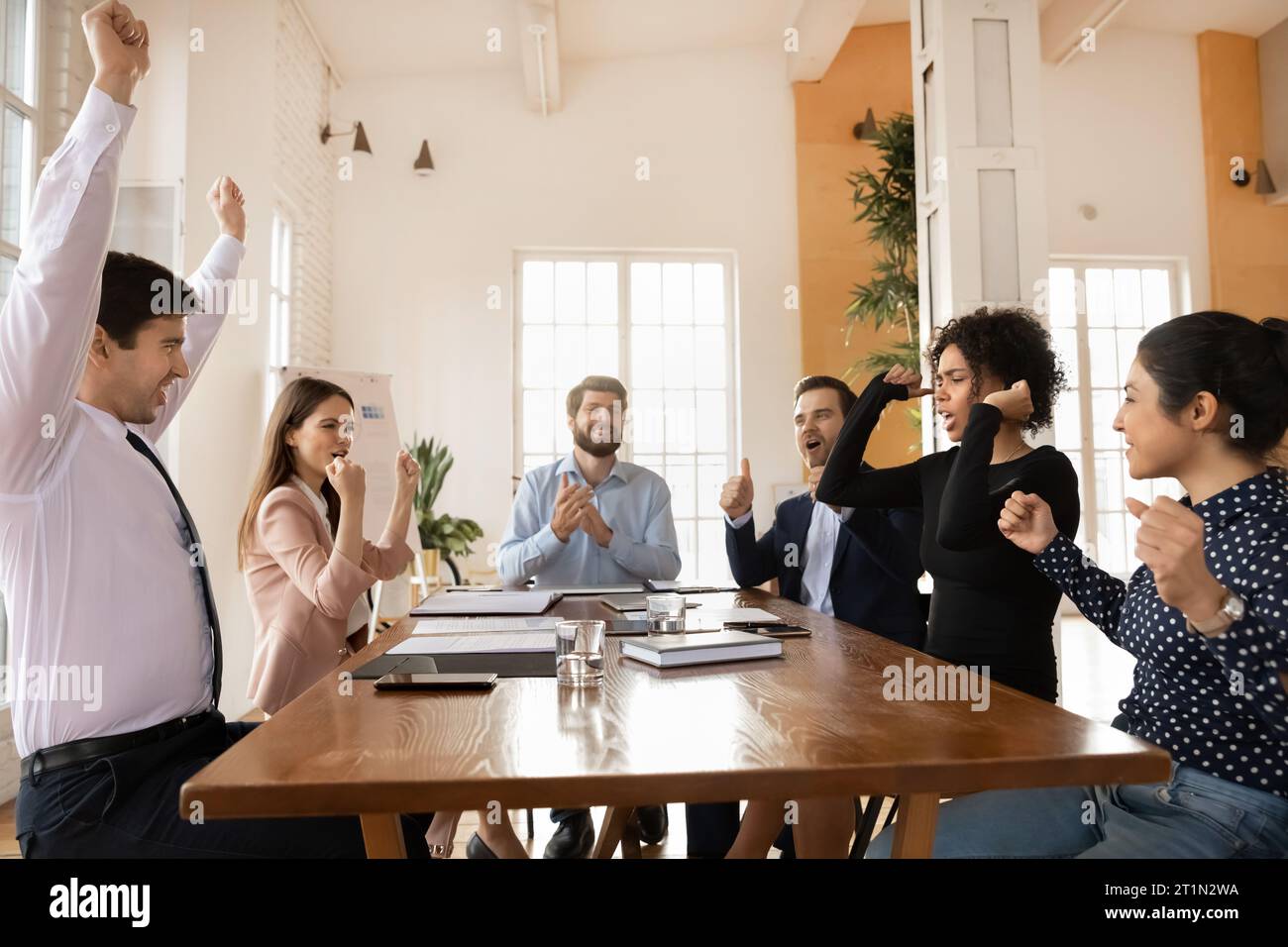 Happy excited diverse business coworkers making winner gestures Stock ...
