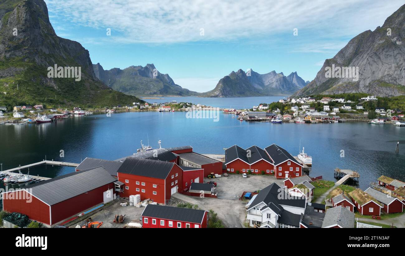 An aerial view of Reine, Norway with a a cluster of red fishing houses ...