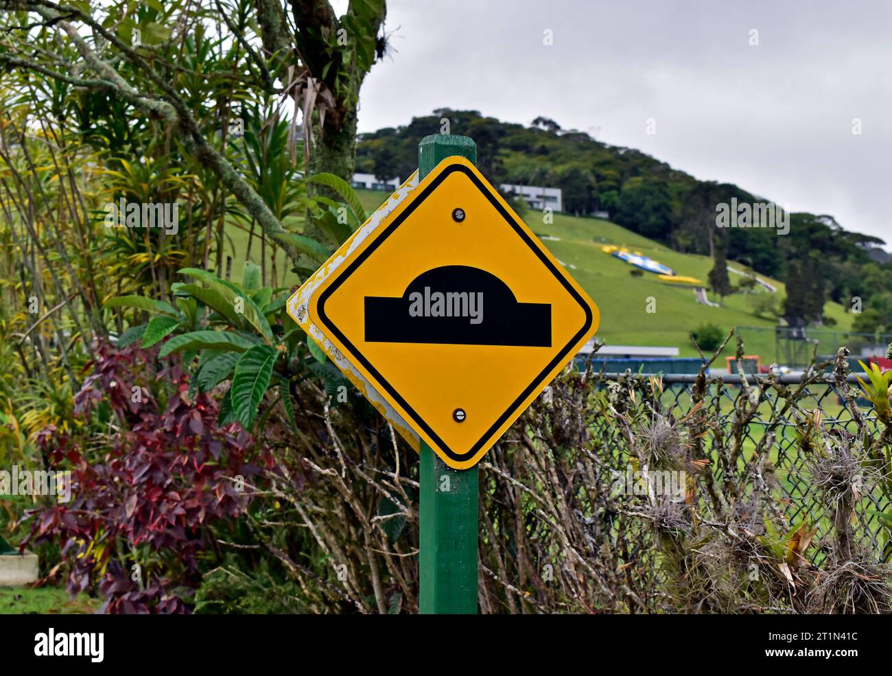 Yellow street traffic warning sign indicating speed bump Stock Photo ...