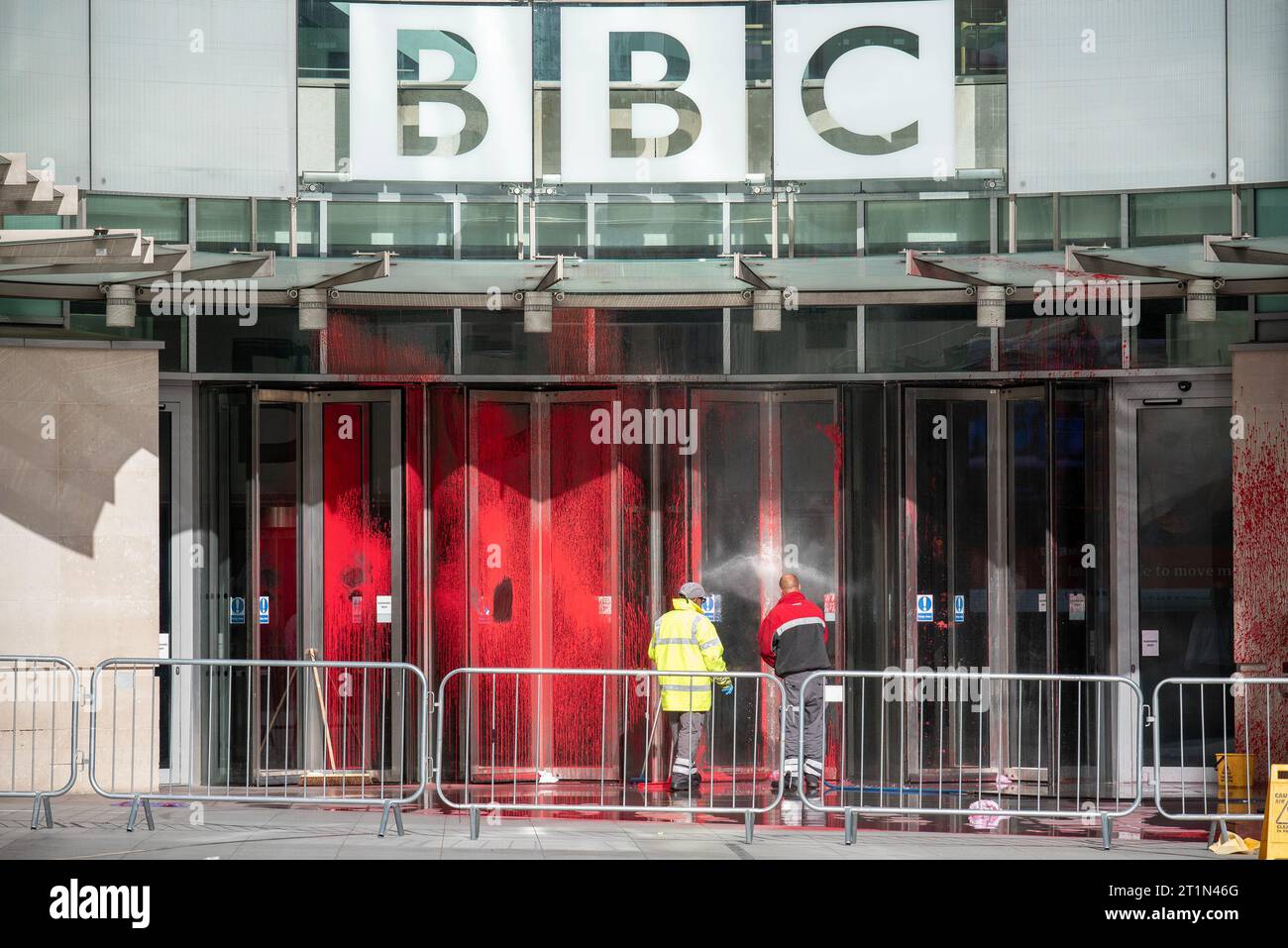 London, UK. 14th Oct, 2023. Workers wash the paint off from the ...