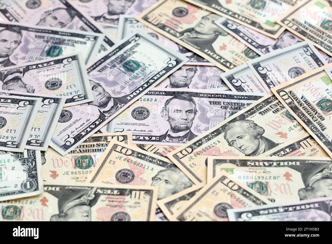 Various US dollar notes scattered. No complete notes shown and angled ...