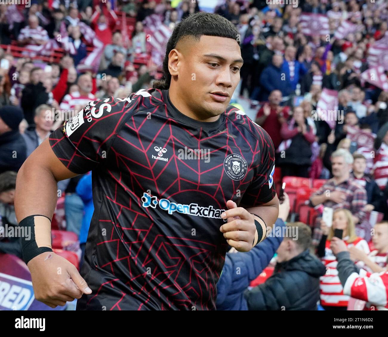 Patrick Mago #20 of Wigan Warriors runs out for the warm up before the ...