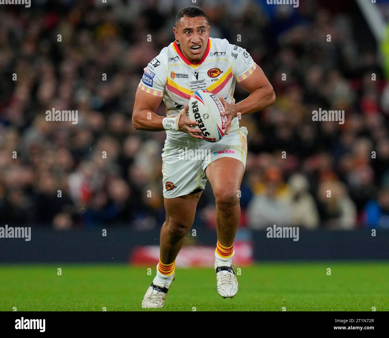 Siua Taukeiaho #22 of Catalans Dragons runs with the ball during the ...