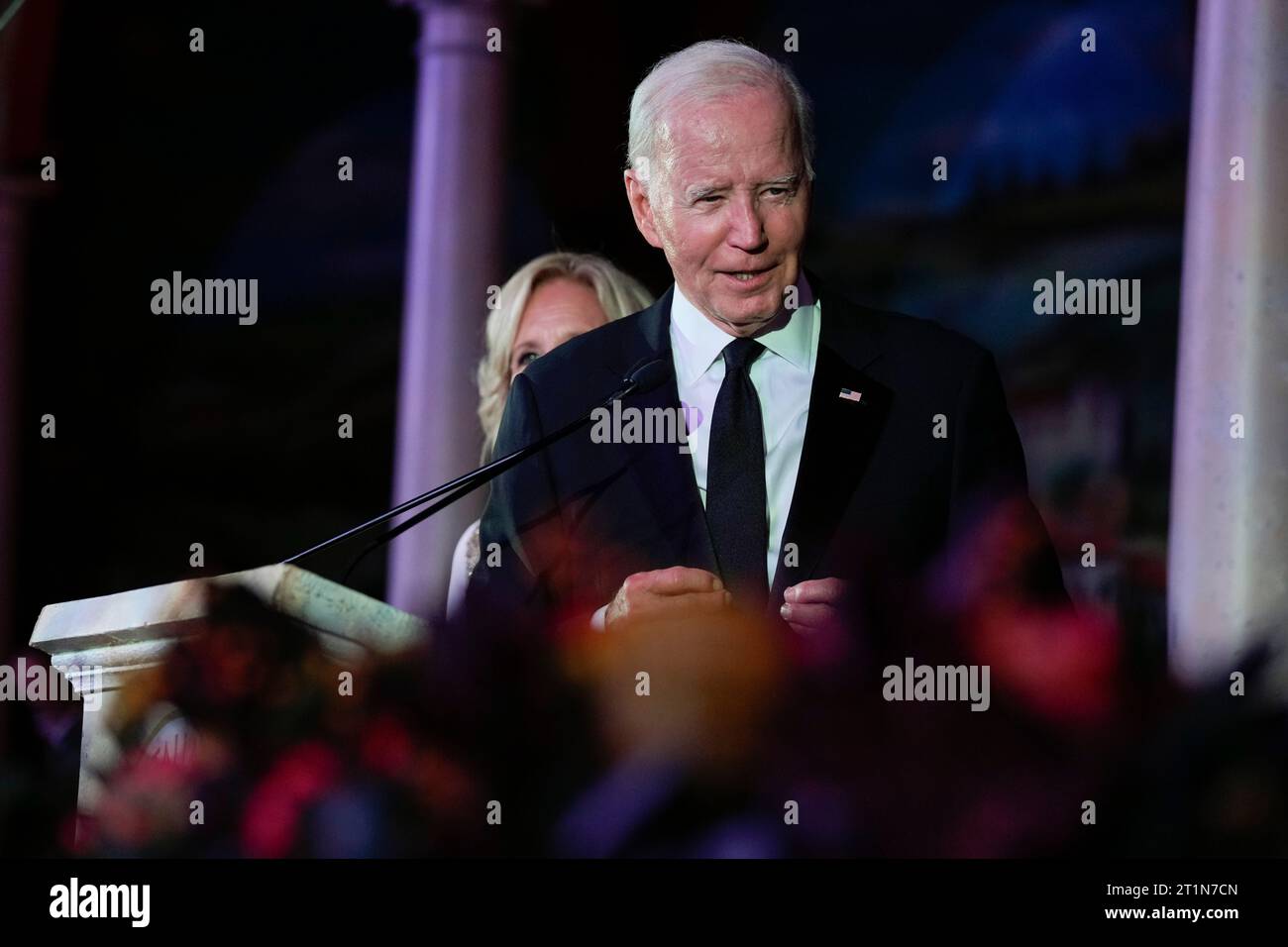 President Joe Biden stands on stage with first lady Jill Biden during ...