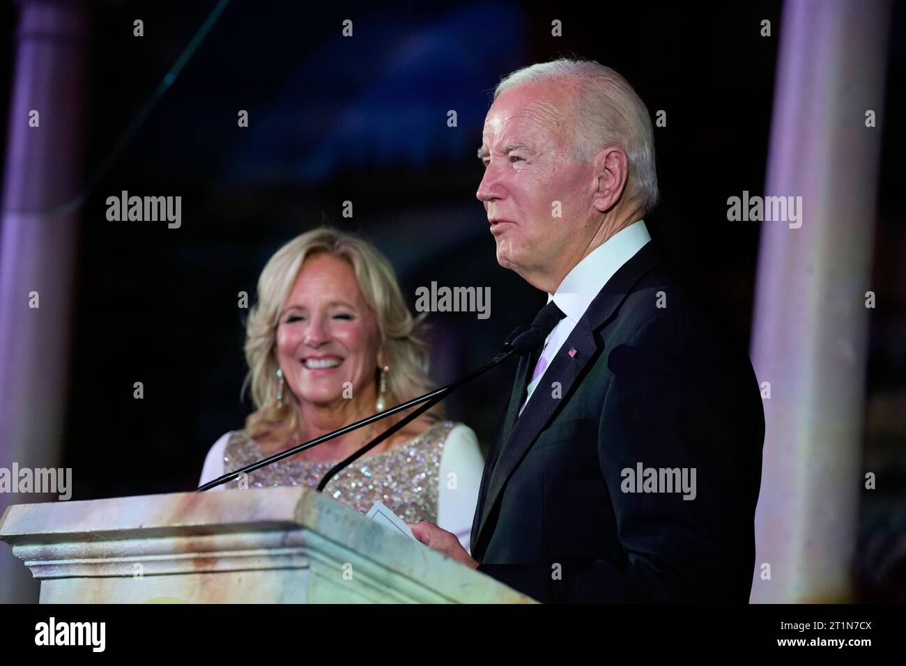 President Joe Biden speaks as he stands on stage with first lady Jill ...