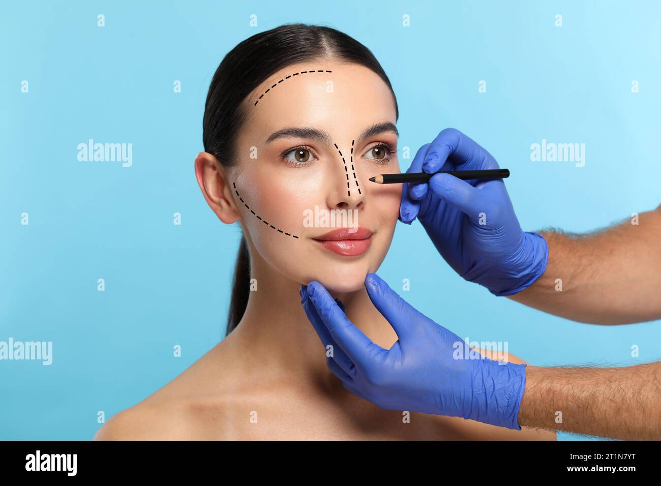 Woman preparing for cosmetic surgery, light blue background. Doctor ...