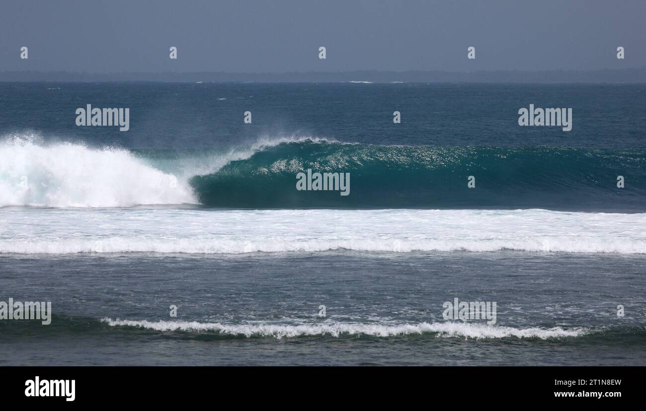 A beautiful wave goes unridden on a coral reef in Sumatra - Indonesia ...
