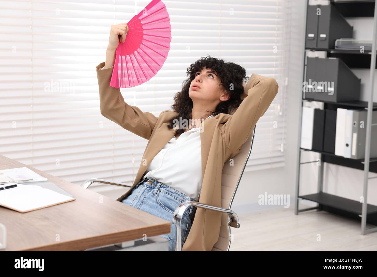 Woman fanning herself indoors in hi-res stock photography and images ...