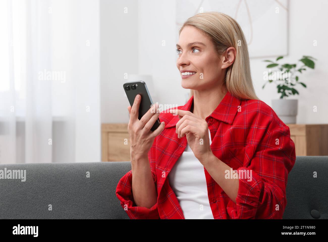 Female sending text message via mobile phone Stock Photo - Alamy