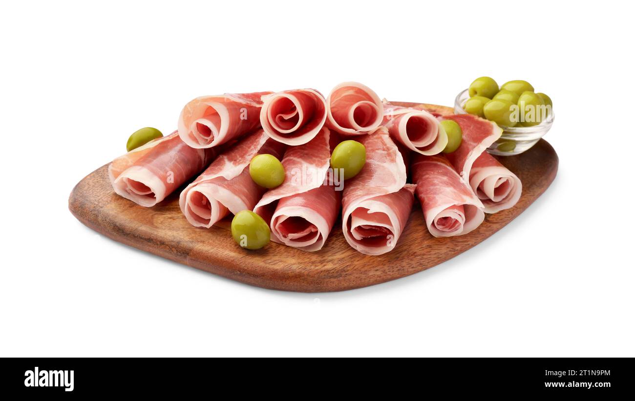 Wooden board with rolled slices of delicious jamon and olives isolated ...