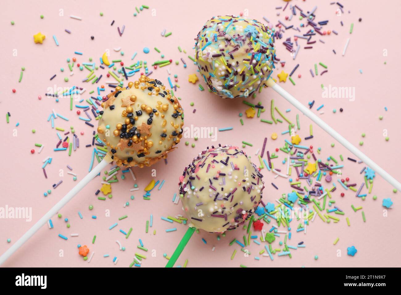 Delicious confectionery. Sweet cake pops decorated with sprinkles on ...