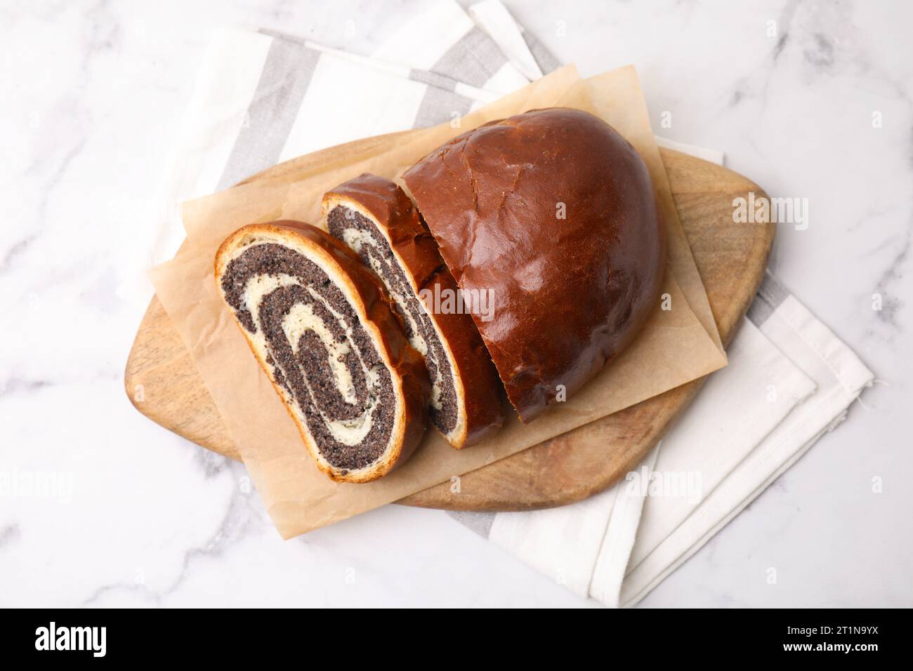 Cut poppy seed roll on white marble table, top view. Tasty cake Stock ...