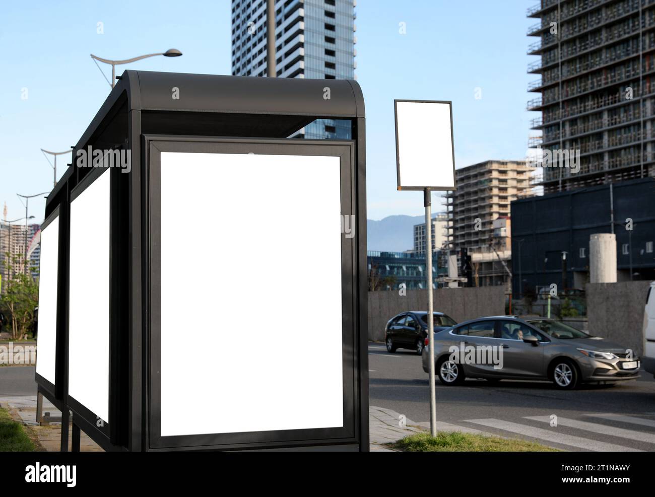 Bus stop with empty signboards in city. Mock-up for design Stock Photo ...