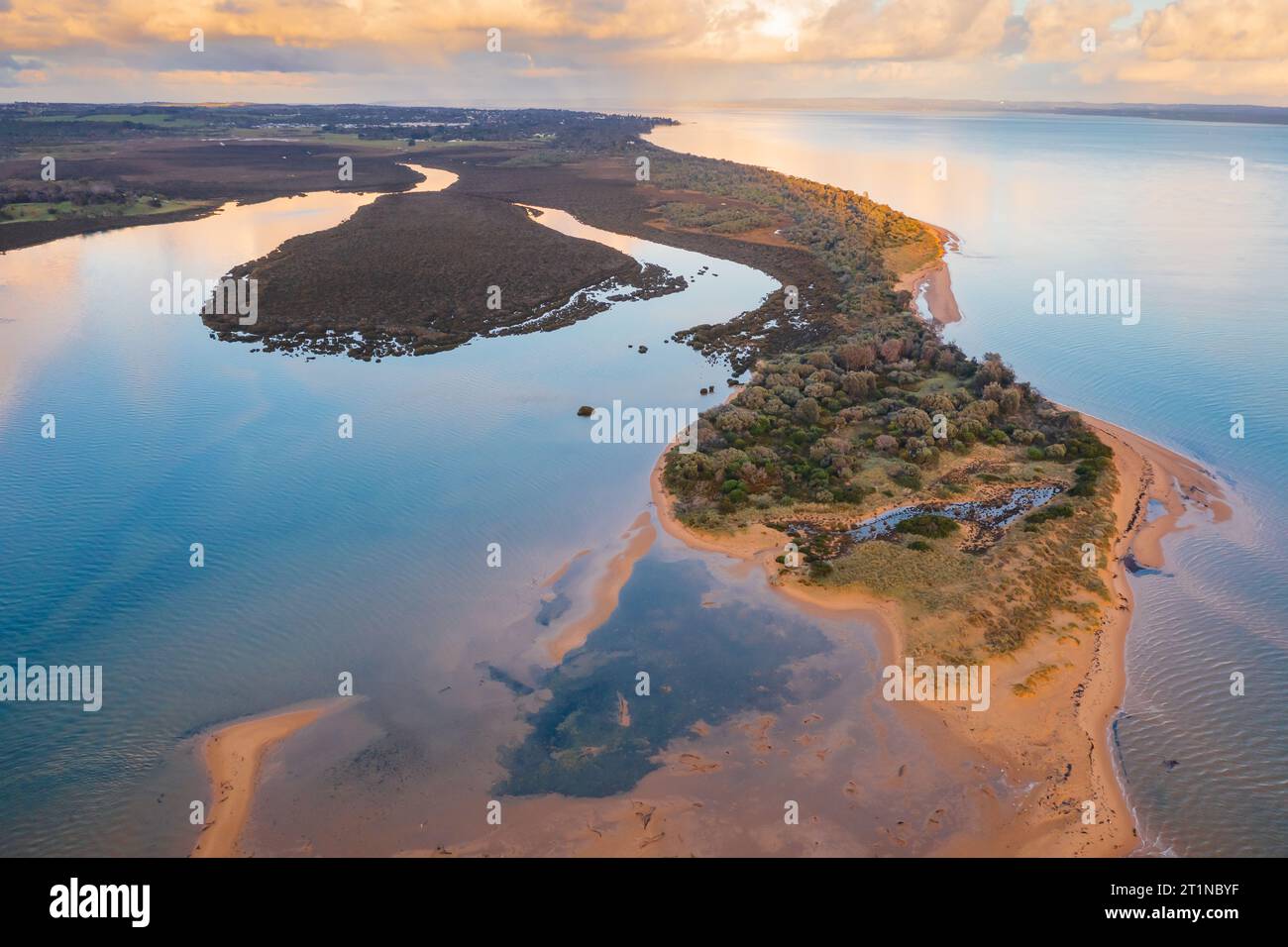 Aerial view of a coastal inlet going out to sea at dawn at the Rhyll ...