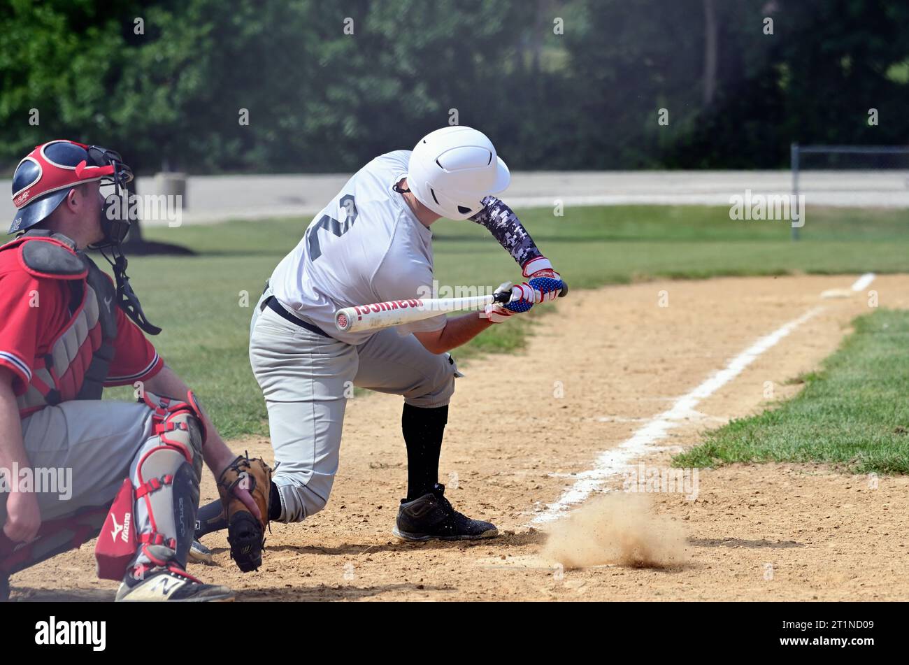 Spring Grove, Illinois, USA. A batter checking his swing on a pitch in ...