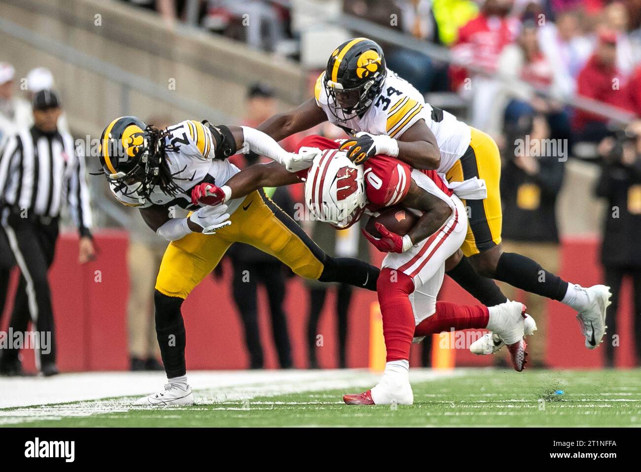 Wisconsin running back Braelon Allen (0) is brought down by Iowa ...