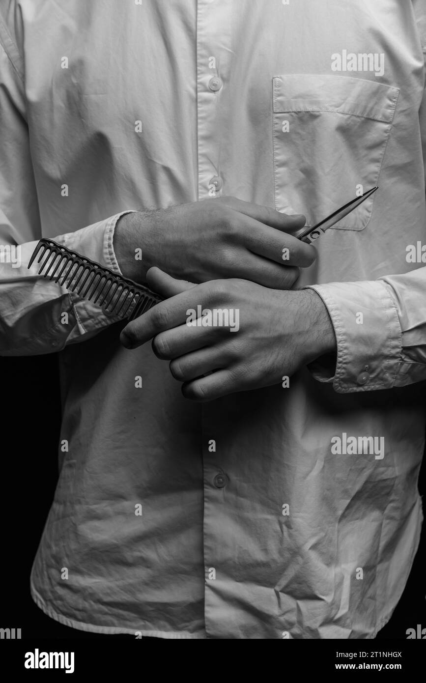 Barber cutting hair scissors comb Black and White Stock Photos & Images ...