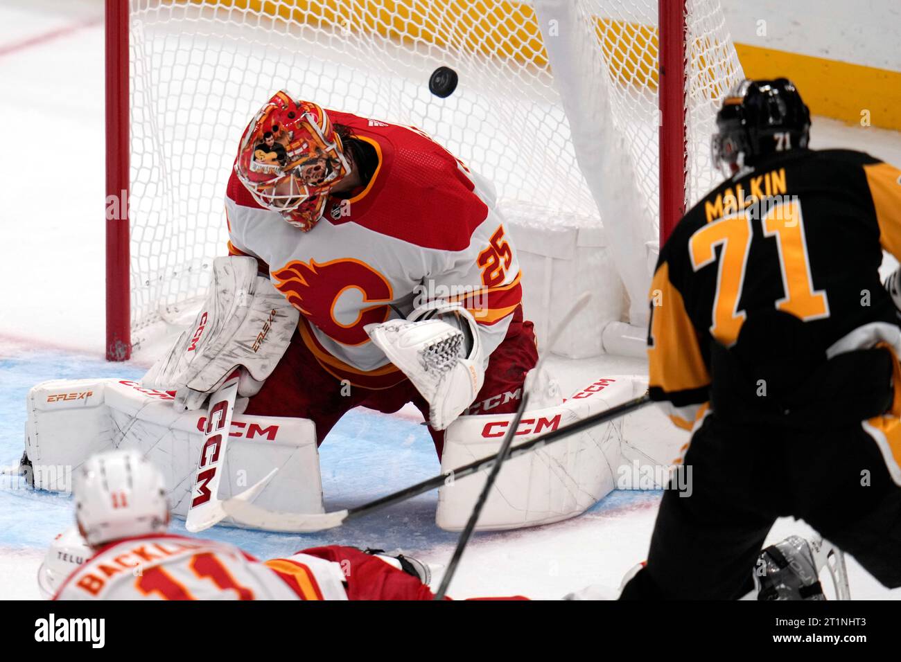 Pittsburgh Penguins' Evgeni Malkin (71) gets a shot past Calgary Flames goaltender Jacob ...