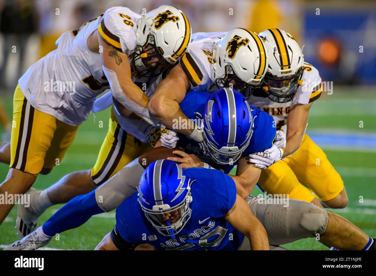 Wyoming defenders Easton Gibbs (28), Cole DeMarzo (25) and Wyett Ekeler ...