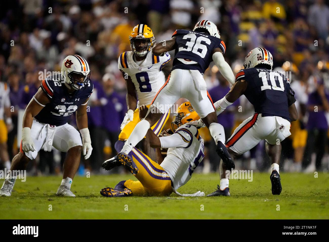 LSU quarterback Jayden Daniels (5) slides to the turf between Auburn ...