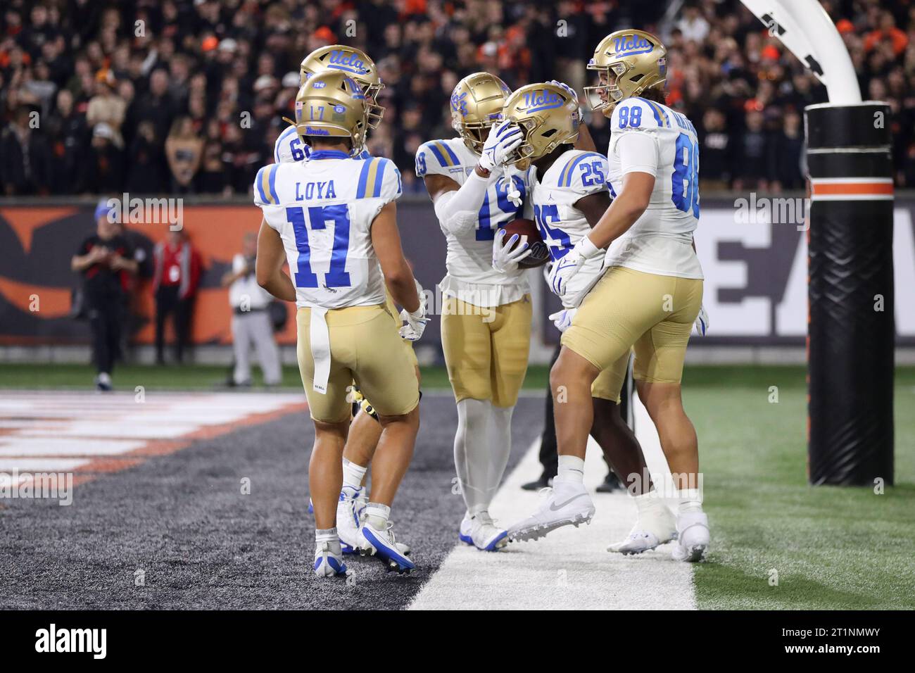 UCLA players celebrate with running back TJ Harden (25), who scored a ...
