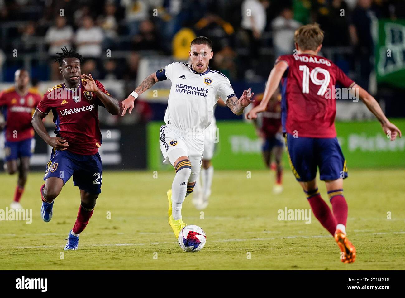 LA Galaxy midfielder Tyler Boyd, center, dribbles the ball as Real Salt ...