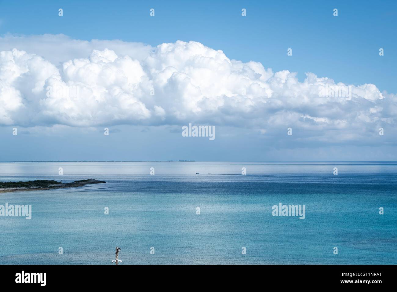 Serene blue sky with white fluffy clouds over the horizon of the ...