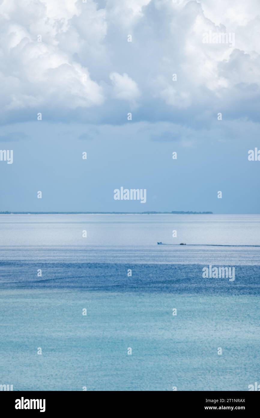 Serene blue sky with white fluffy clouds over the horizon of the ...